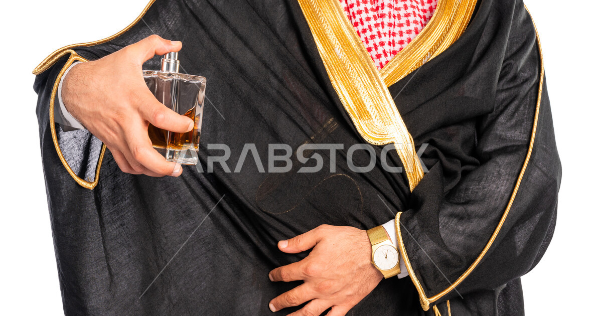 A close-up portrait of a Saudi Arabian Gulf groom in a black bisht ...