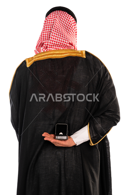 A close-up portrait of a Saudi Arabian Gulf groom in a black bisht ...