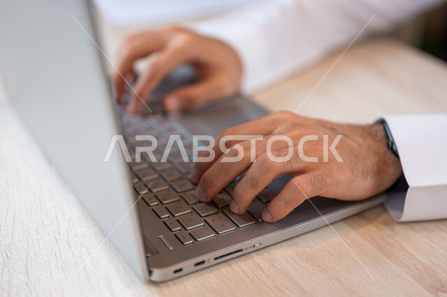 A close-up of the hand of a Saudi Arabian Gulf man, business management ...