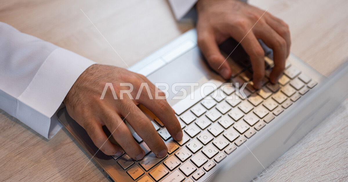 A close-up of the hand of a Saudi Arabian Gulf man, business management ...