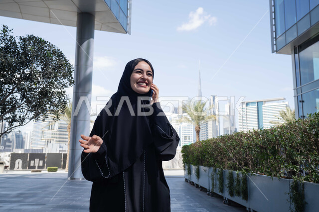 امرأة اماراتية تقوم بإستخدام الأجهزة التقنية الحديثة، الدردشة عبر مواقع ...