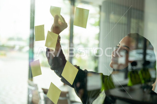 Writing and taking notes, colorful sticky notes, work environment in ...