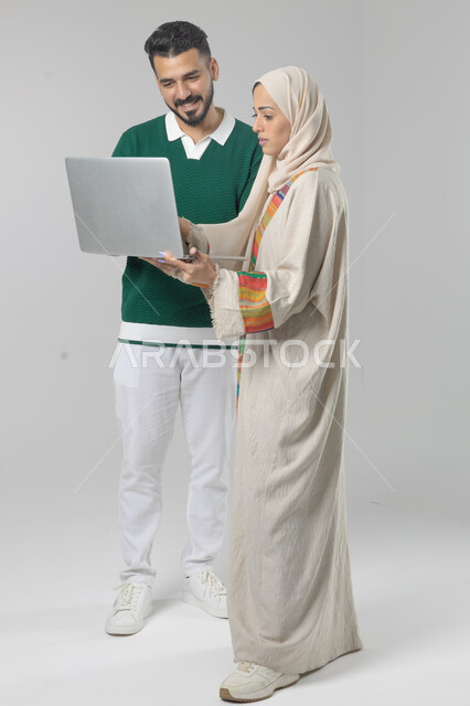 Teamwork and team spirit, portrait of two Saudi Arabian Gulf colleagues ...