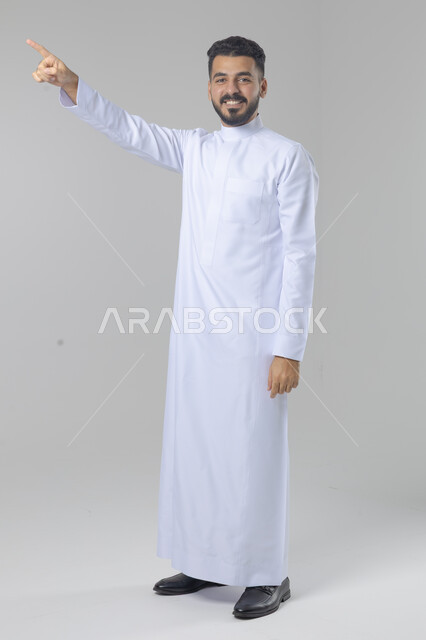 Pointing to something, standing up straight, portrait of a Saudi ...