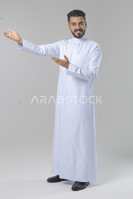 Pointing to something, standing up straight, portrait of a Saudi ...