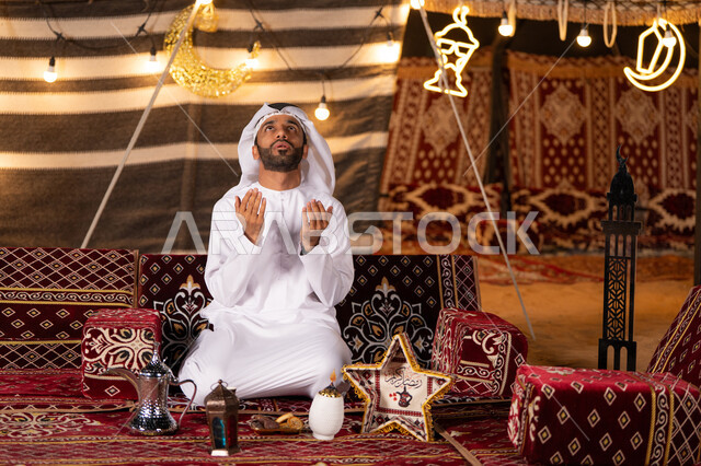 Supplication, humility and worship, an Emirati Gulf Arab man wearing a ...