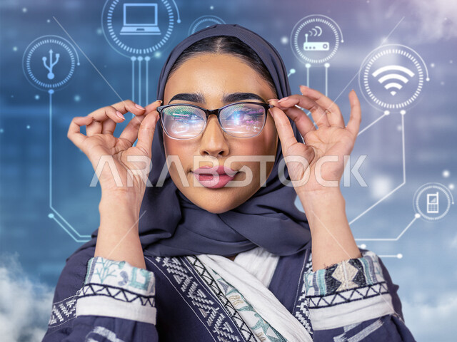 A Saudi Arabian Gulf woman wearing VR 3D glasses, 3D hologram graphics ...