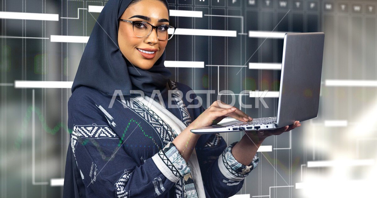 A Saudi Arabian Gulf woman performs her work through a computer, follow ...
