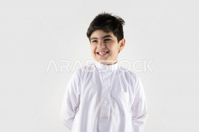 Portrait of a Saudi Arabian Gulf boy with facial gestures indicating ...