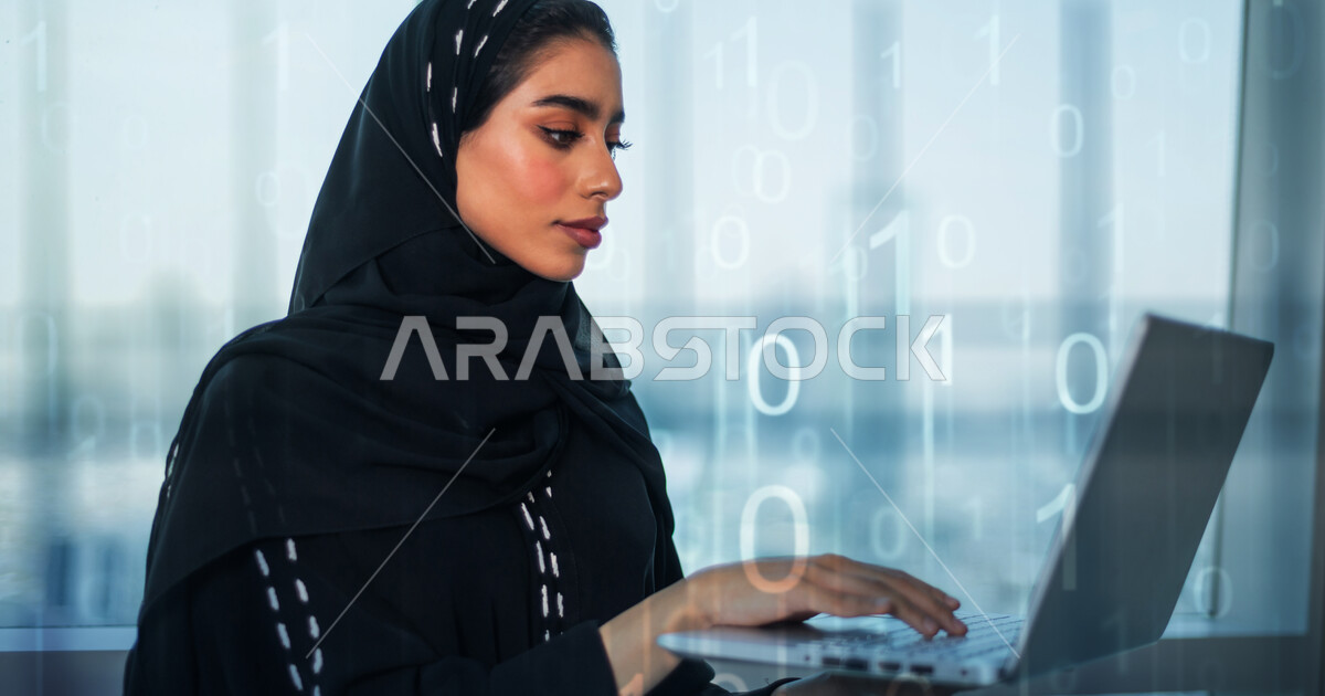 A Saudi Arabian Gulf woman using a laptop, working as a web developer ...