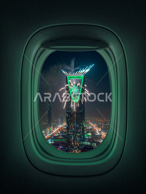 A picture of the plane window overlooking the Kingdom Tower in the city ...