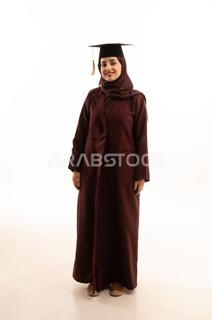 A portrait of a Saudi graduate wearing an abaya and graduation cap ...