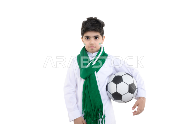 Portrait of a Saudi Arabian Gulf Arab boy holding a soccer ball ...