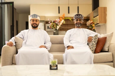 Two Arab Gulf Saudi children wearing traditional attire are sitting ...