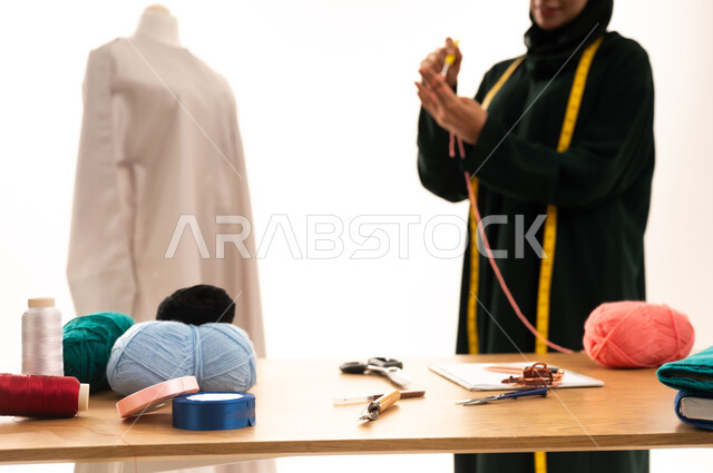 The practice of fashion design, a close-up portrait of a Saudi Gulf ...
