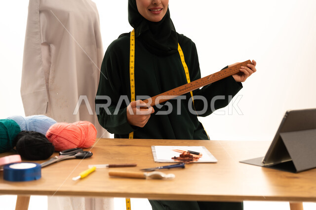 Using sewing tools and equipment, mastering the making of Saudi ...