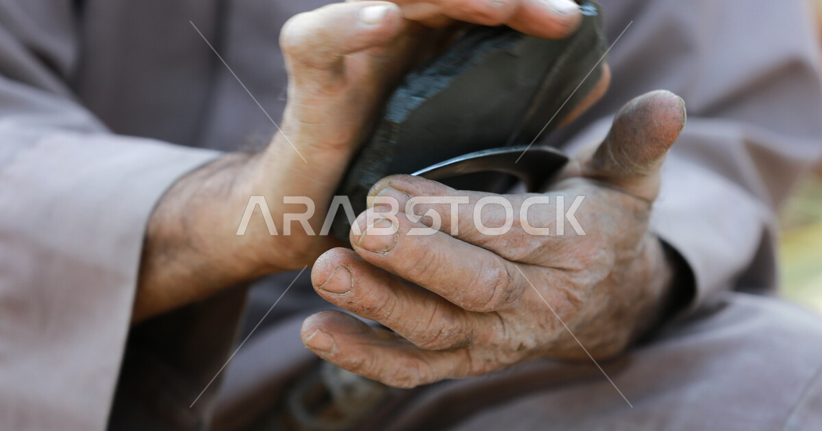 An Arab Gulf farmer sharpening the agricultural sickle, harvesting tool ...