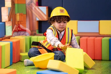 Two Arab Gulf Saudi children wearing traditional attire are sitting ...
