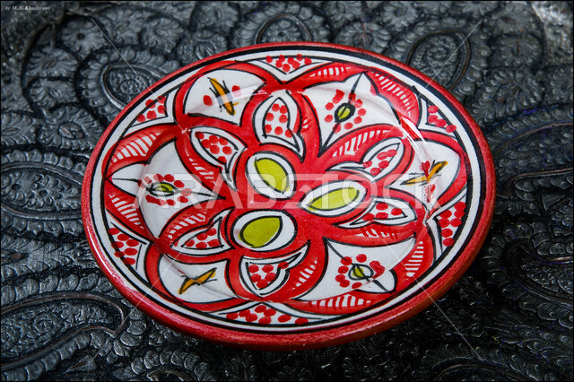 A picture of a colorful ceramic dish decorated with colorful Arabic ...
