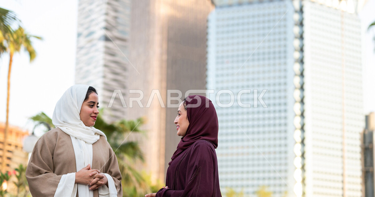 Two Saudi Arabian Gulf ladies talking to each other, touring in King ...