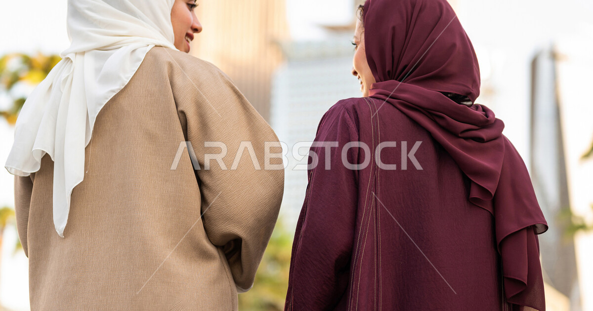 Two Saudi Arabian Gulf ladies talking to each other, touring in King ...