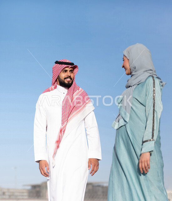 A happy Saudi Arabian Gulf couple walking in one of Riyadh's parks ...