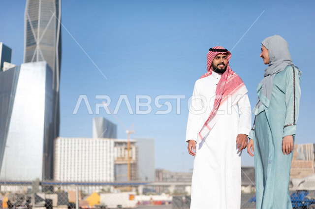 A happy Saudi Arabian Gulf couple walking in one of Riyadh's parks ...