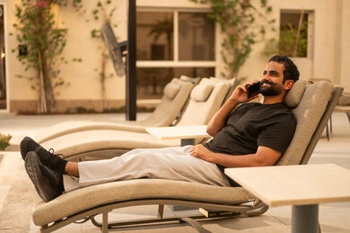 A Saudi Arabian Gulf Arab man dressed in casual attire is making a ...