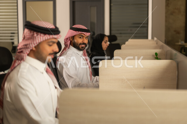 Arab Saudi Gulf colleagues wearing traditional attire and shemagh using ...