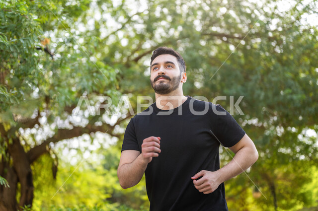 An Arab man doing morning sports in the open air, jogging, exercising ...