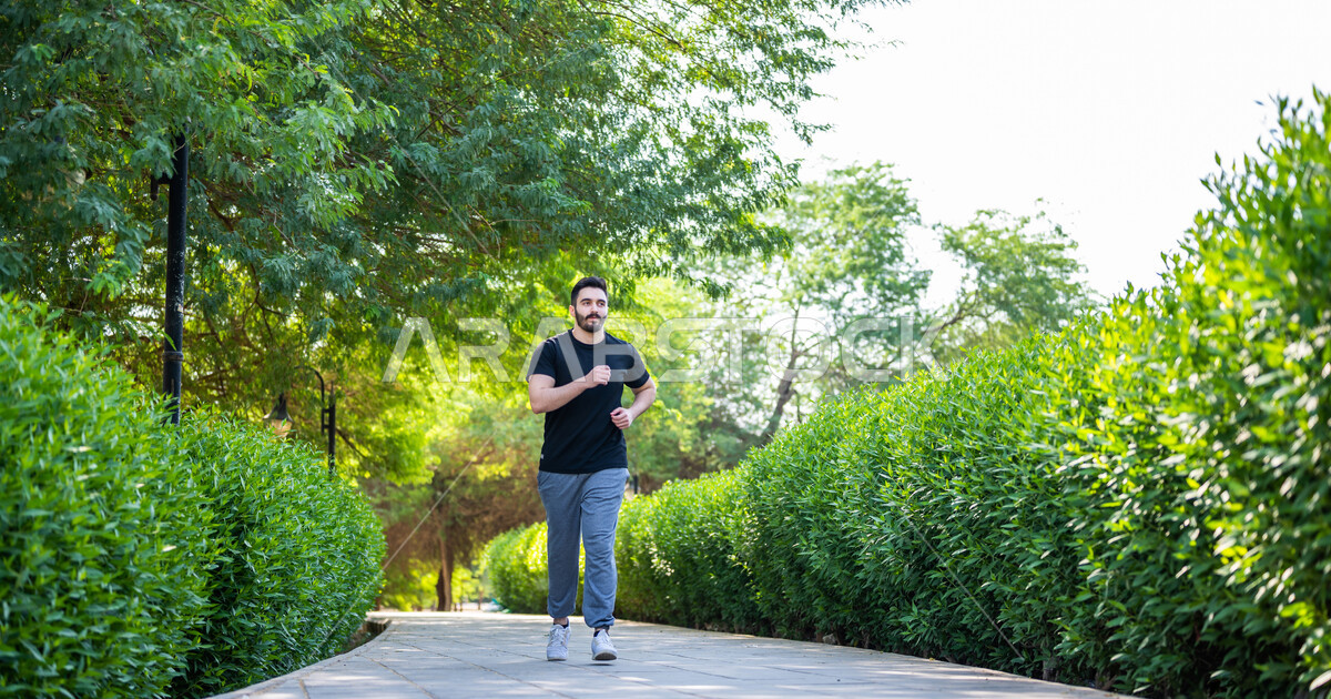 An Arab man doing morning sports in the open air, jogging, exercising ...
