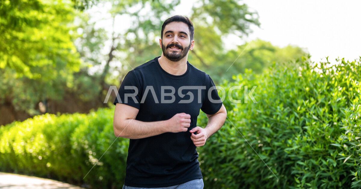An Arab man doing morning sports in the open air, jogging, exercising ...