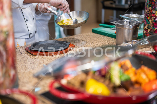 A Saudi Arabian Gulf cook prepares food to be served in the restaurant ...