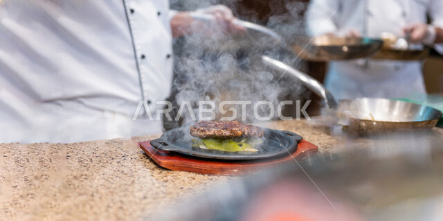 A Saudi Arabian Gulf cook prepares food to be served in the restaurant ...