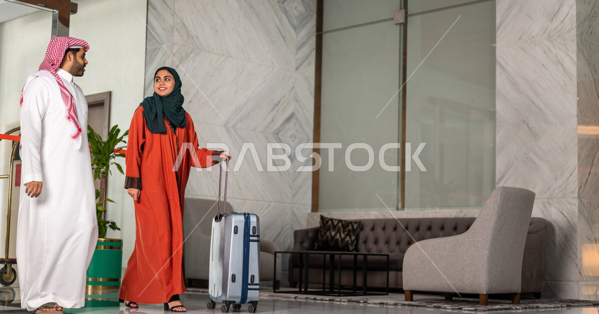 A Saudi Arabian couple, tourists walking and roaming in the lobby of ...