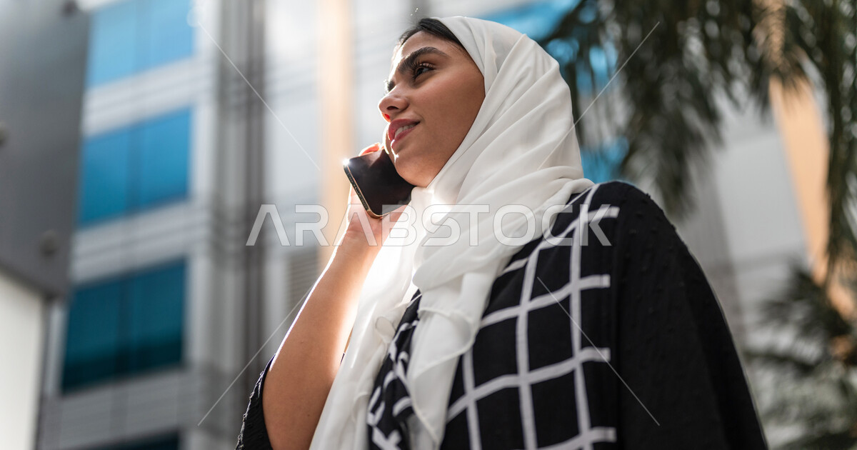 A Saudi Arabian Gulf woman inside the tourist hotel, making a phone ...