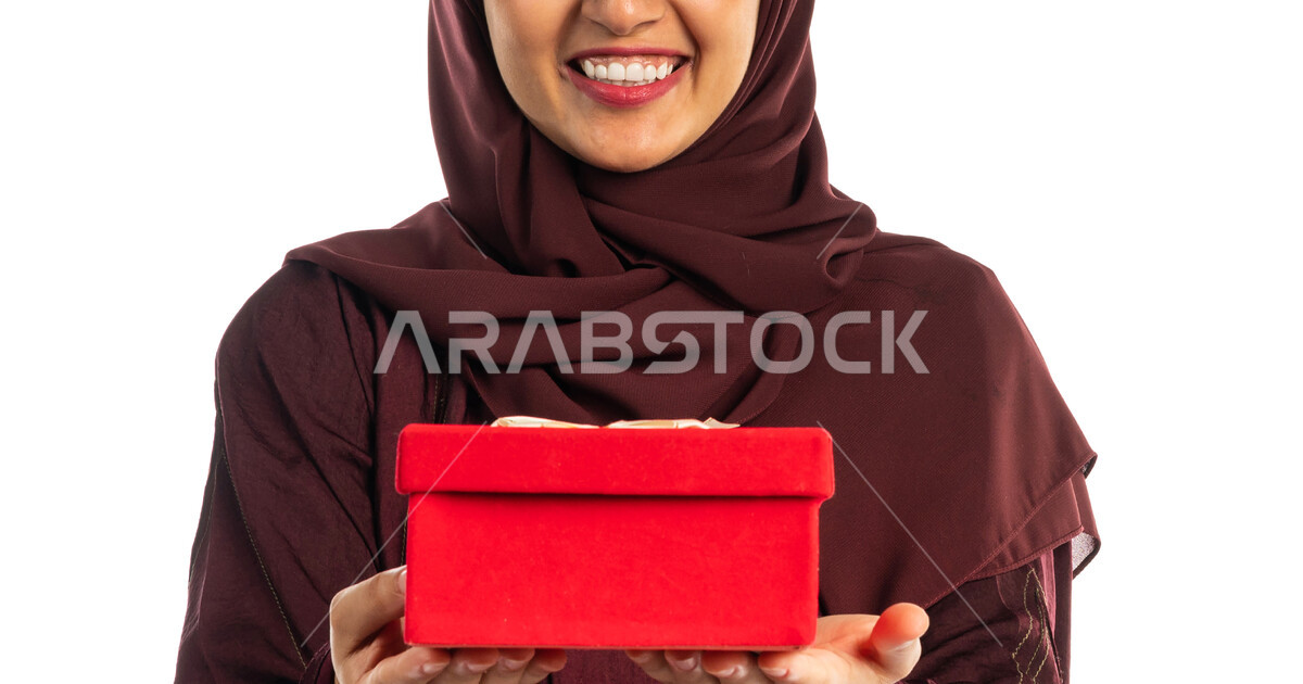 Portrait of a Saudi Arabian Gulf woman holding a red box in her hand ...
