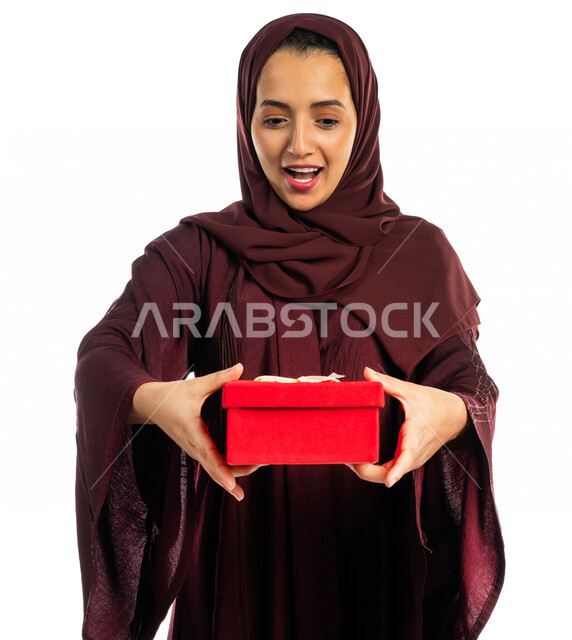 Portrait of a Saudi Arabian Gulf woman holding a red box in her hand ...