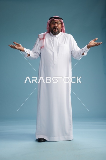 A portrait of an Arab Saudi Gulf man wearing a white thobe and a ...