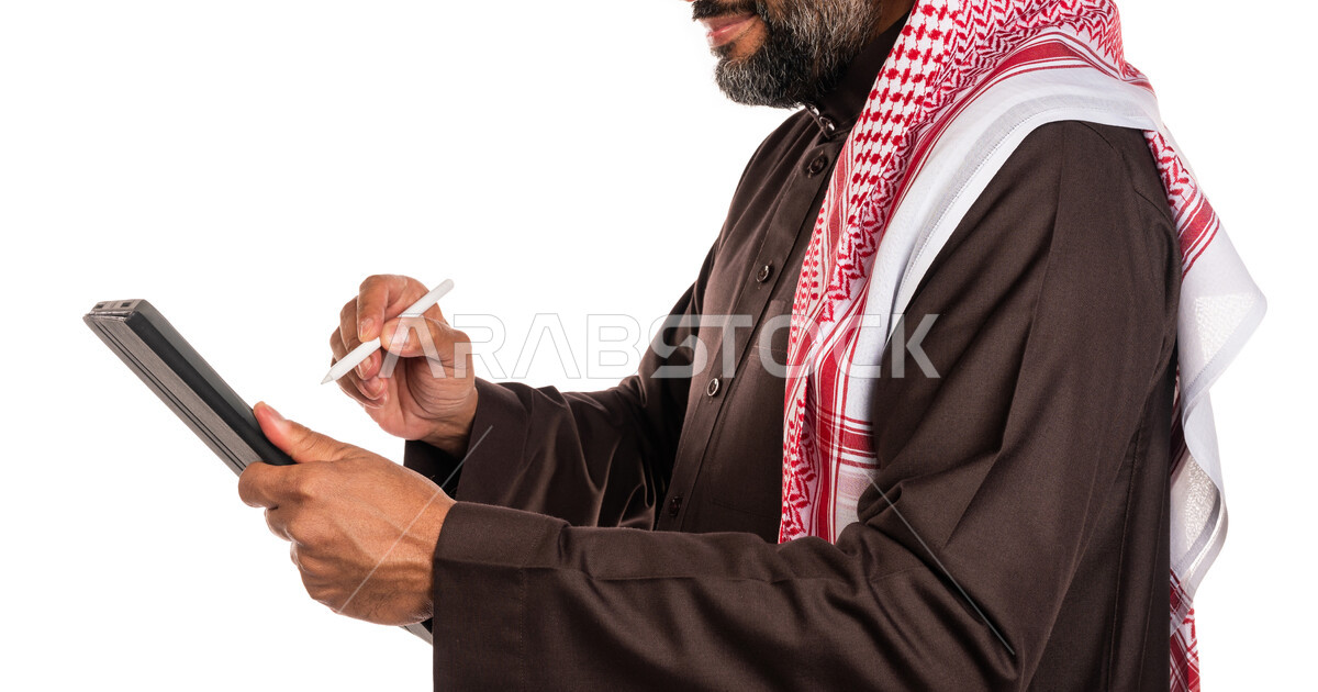 Portrait of a Saudi Arabian Gulf man using a mobile tablet, e-marketing ...