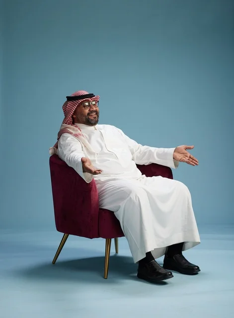 A portrait of a Saudi Arabian Gulf man wearing a white thobe sitting on ...