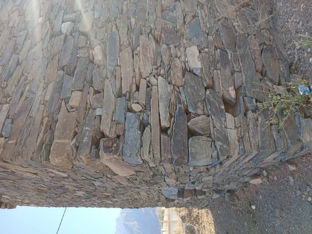 The green plants around the houses and ancient stone buildings in the ...