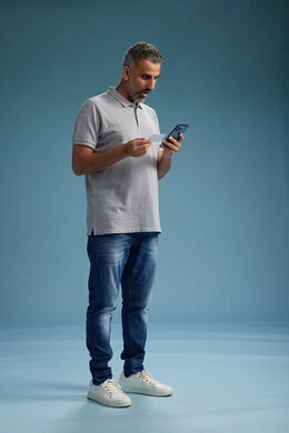 A Saudi Arabian Gulf Arab man dressed in casual attire is making a ...