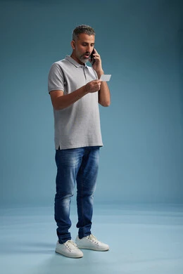 A Saudi Arabian Gulf Arab man dressed in casual attire is making a ...