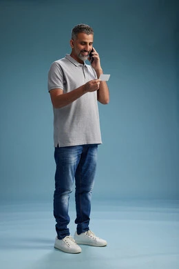 A Saudi Arabian Gulf Arab man dressed in casual attire is making a ...