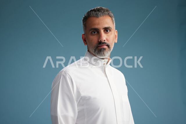 A close-up photograph of a Saudi Arabian Gulf man wearing a white thobe ...