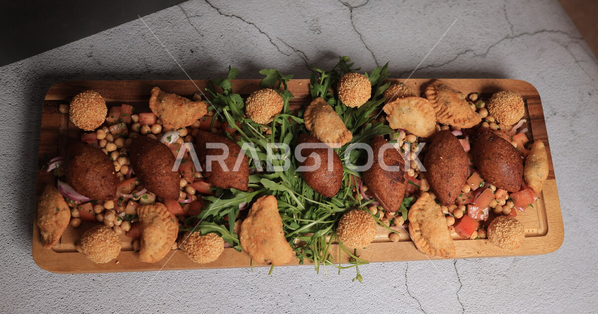 Picture of a plate of fried food, golden kibbeh and delicious samosas ...