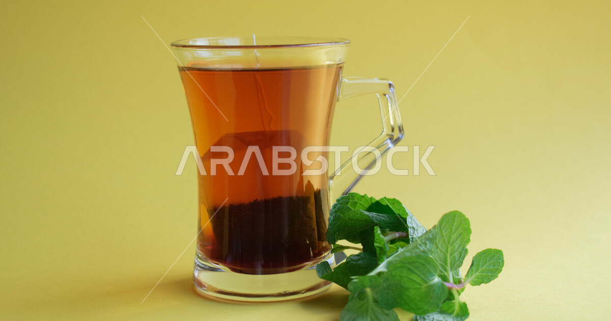 صورة مقربة لفنجان شاي مع أوراق النعنع الخضراء ، مشروب ساخن لذيذ ...