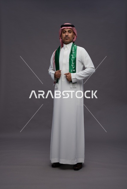 Saudi Man In Traditional Dress With National Scarf Photo