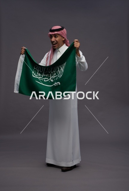 Saudi Man Holding Saudi Arabian National Flag Portrait - Photo